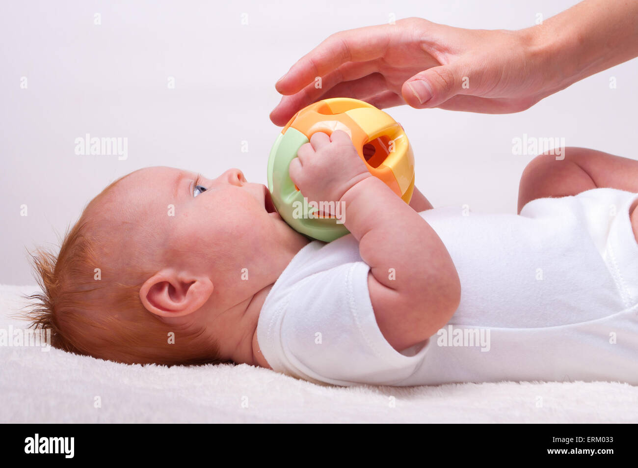 Infant hand toy hi-res stock photography and images - Alamy