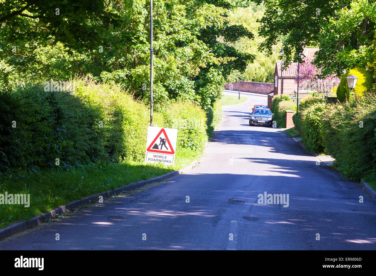 Mobile roadworks ahead road sign on street verge UK England signs Stock ...