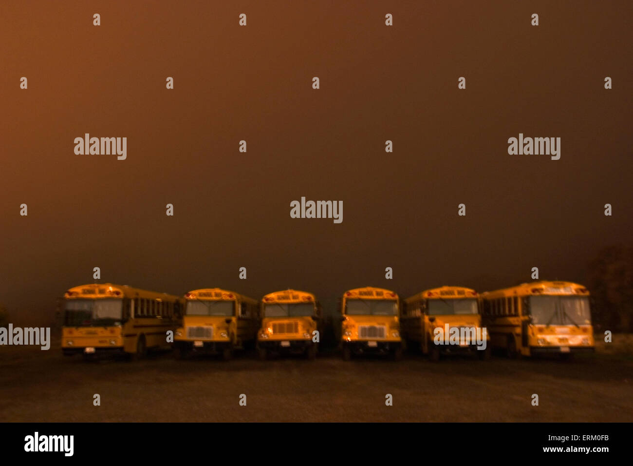 Buses sit in line beneath a brown colored, foggy sky. Auburn California ...