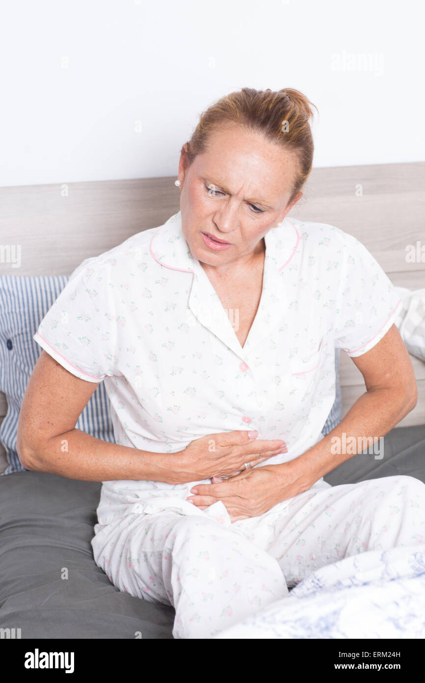 Woman crouching in pain hi-res stock photography and images - Alamy