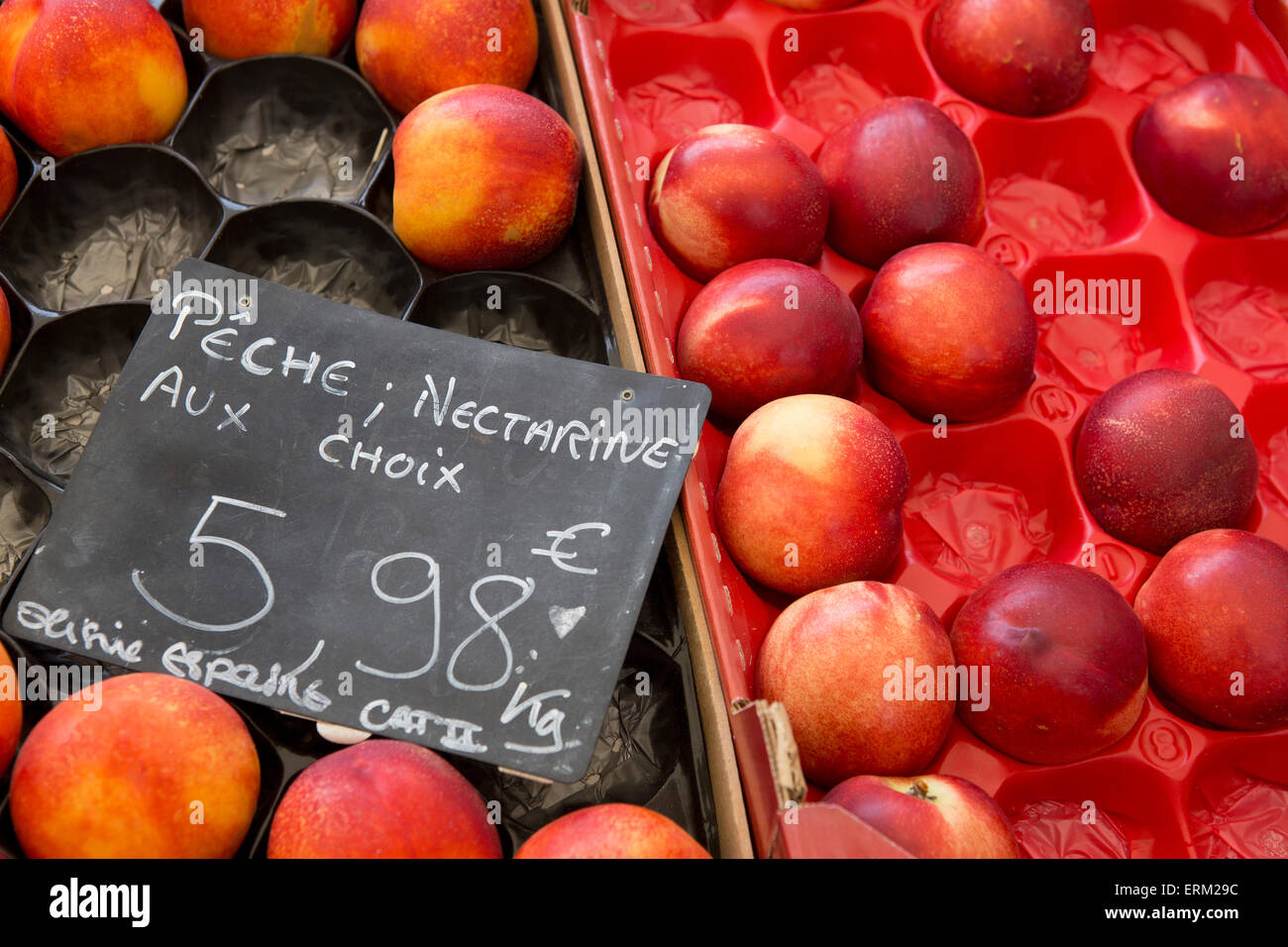 Boxes of nectarines on a fruit stall with a price label Stock Photo - Alamy