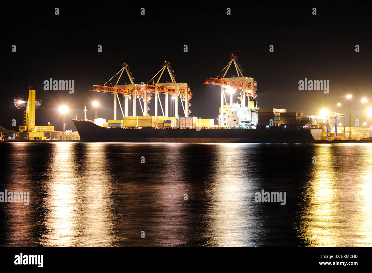 Container cargo ship in port at night Stock Photo - Alamy