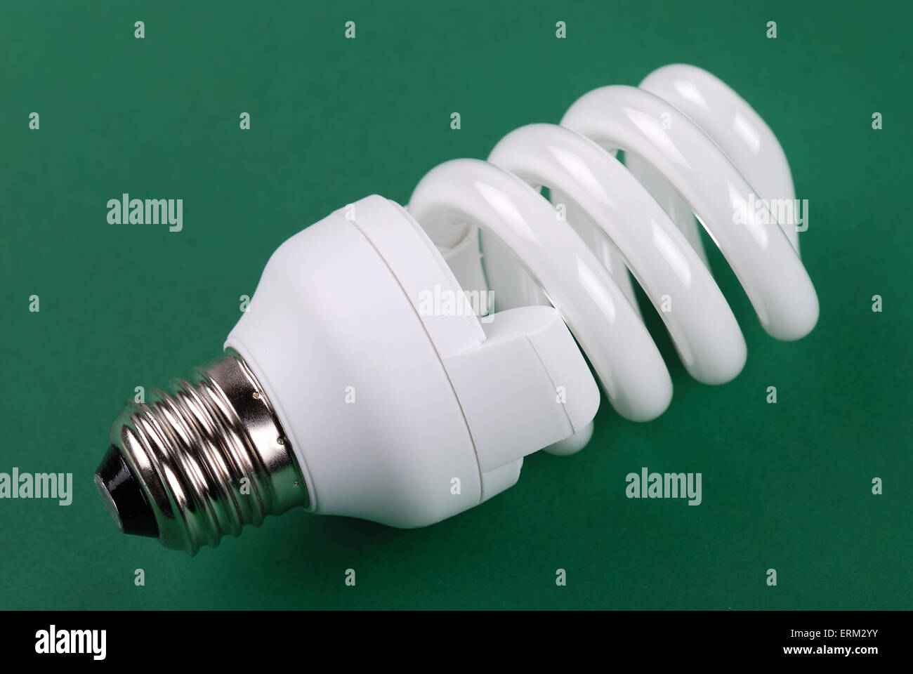 energy saving bulb on green background Stock Photo - Alamy