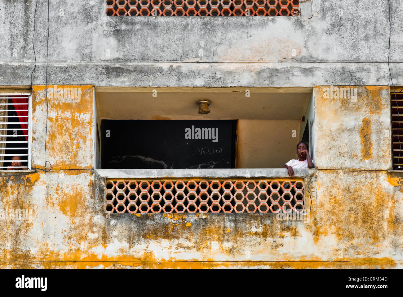 A Cuban girl looks from the balcony in the apartment block in Alamar, a ...