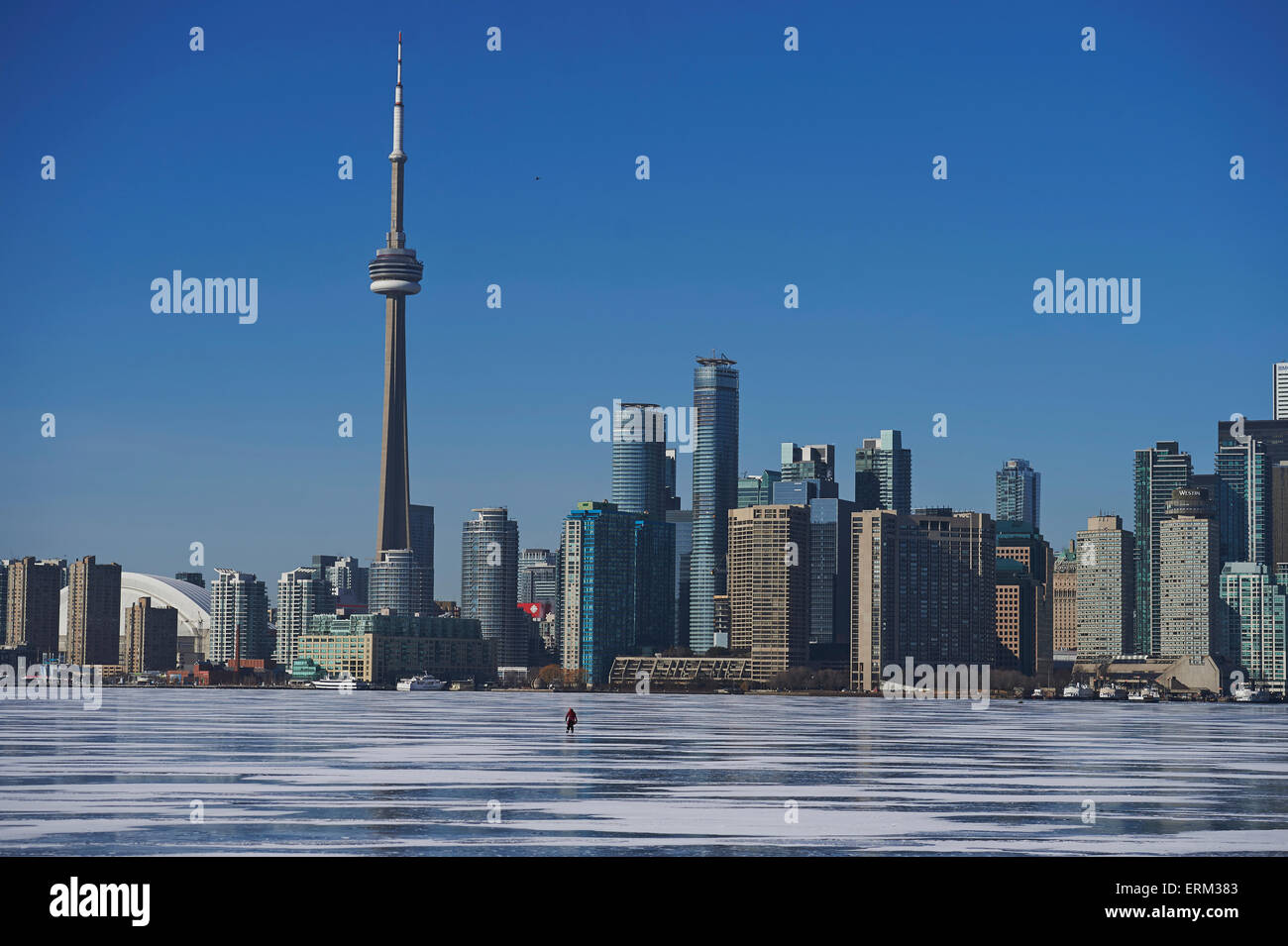 Skater against city skyline in winter; Toronto, Ontario, Canada Stock ...