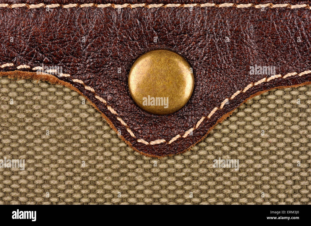 rivet button on the leather and fabric. macro photo Stock Photo - Alamy