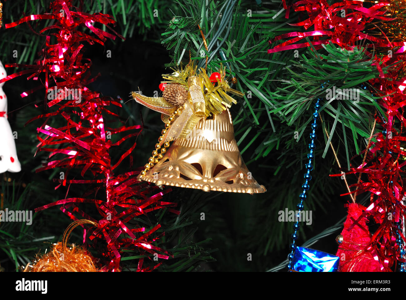 Golden bell hanging on fir tree with other decoration Stock Photo - Alamy