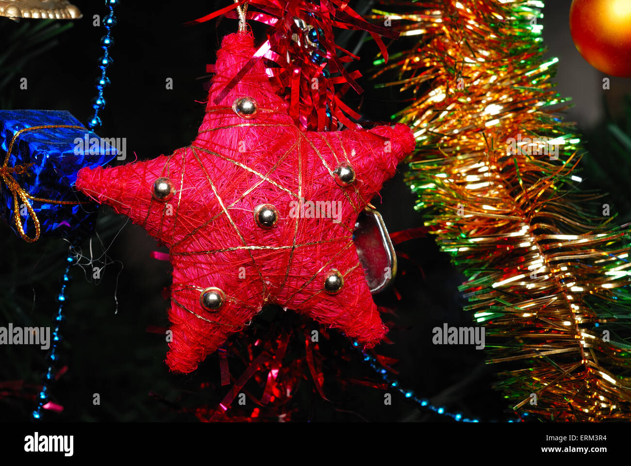 Red star hanging on fir tree with other decoration Stock Photo - Alamy