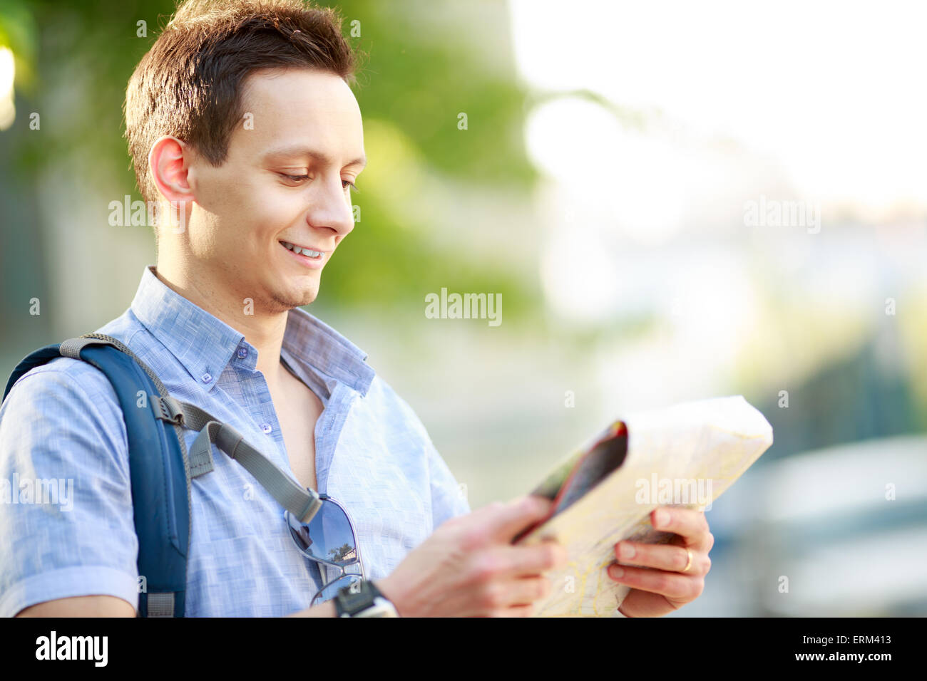 Young man with map Stock Photo - Alamy