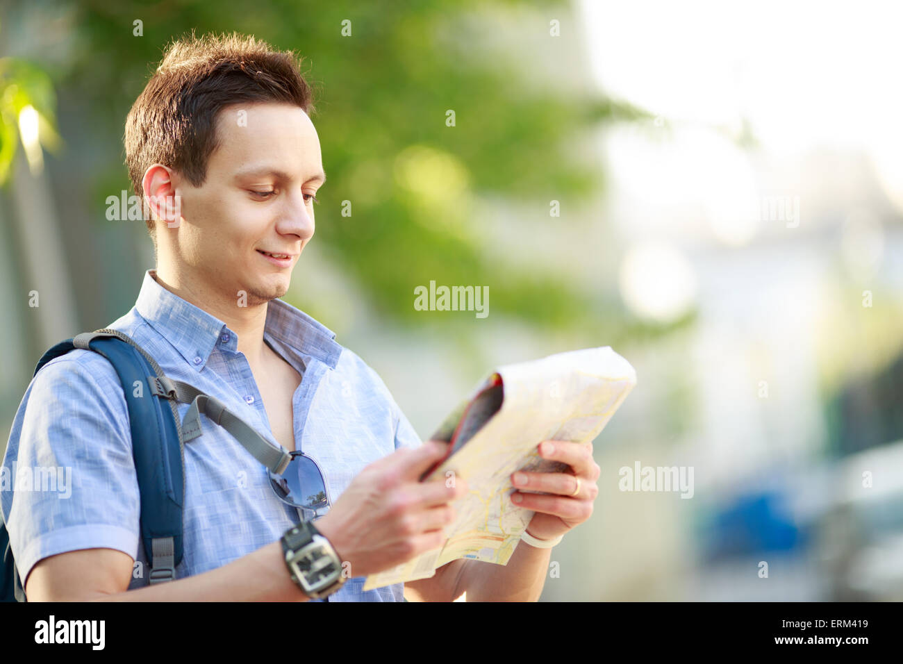 Young man with map Stock Photo - Alamy