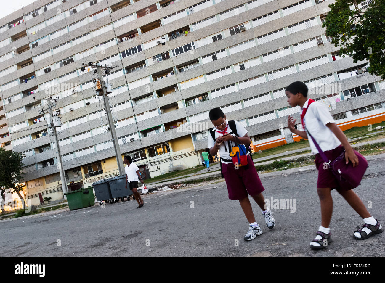 Cuban school mates walk in front of the large apartment block in Alamar ...