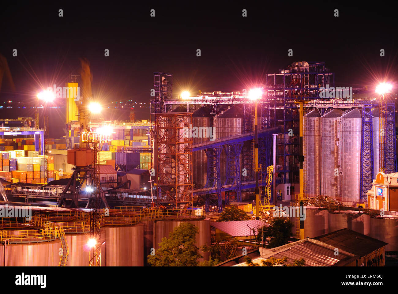 Port warehouse with cargoes and containers at night Stock Photo - Alamy