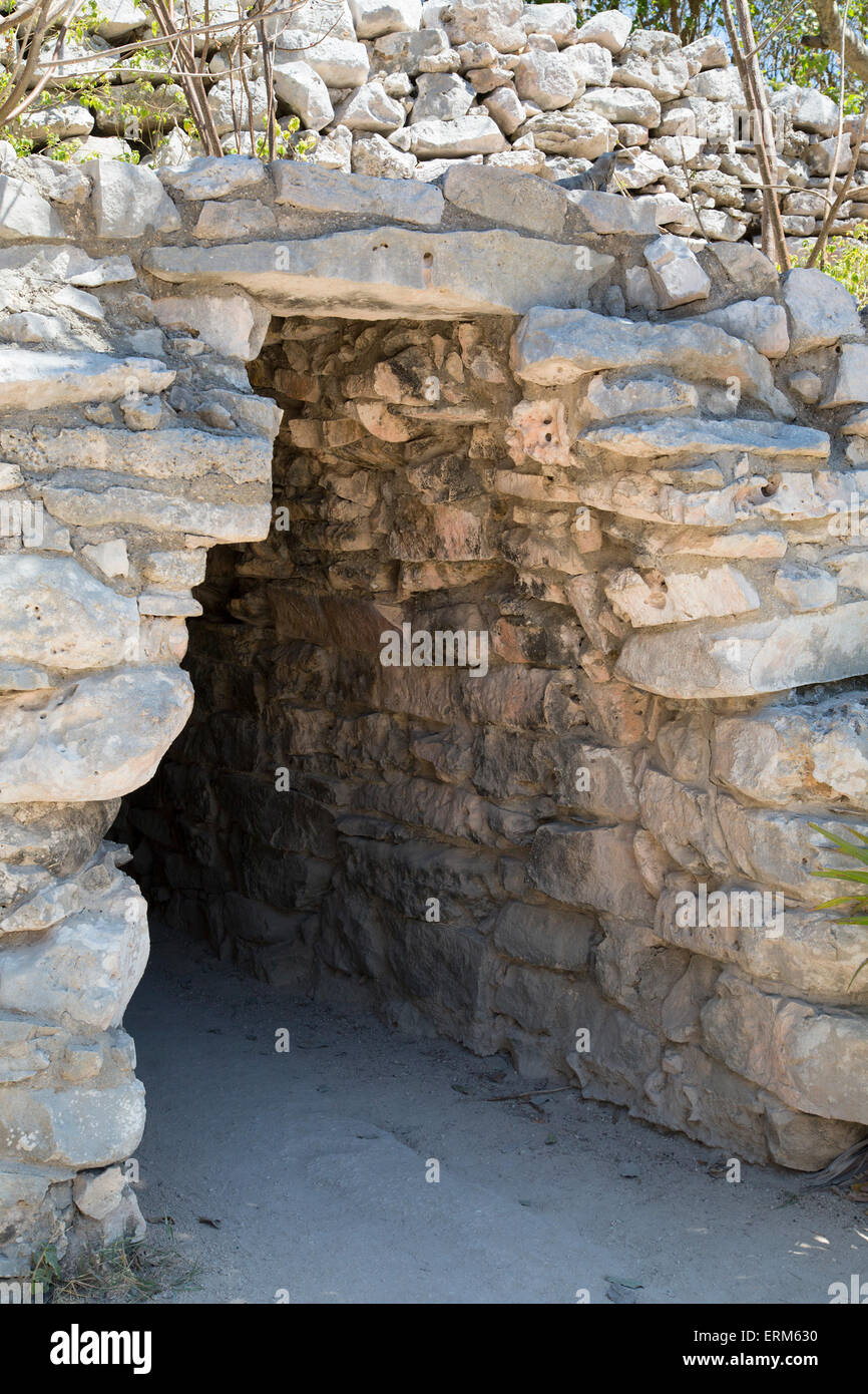 Entrance archway to Mayan ruins in the old stone wall surrounding Tulum ...