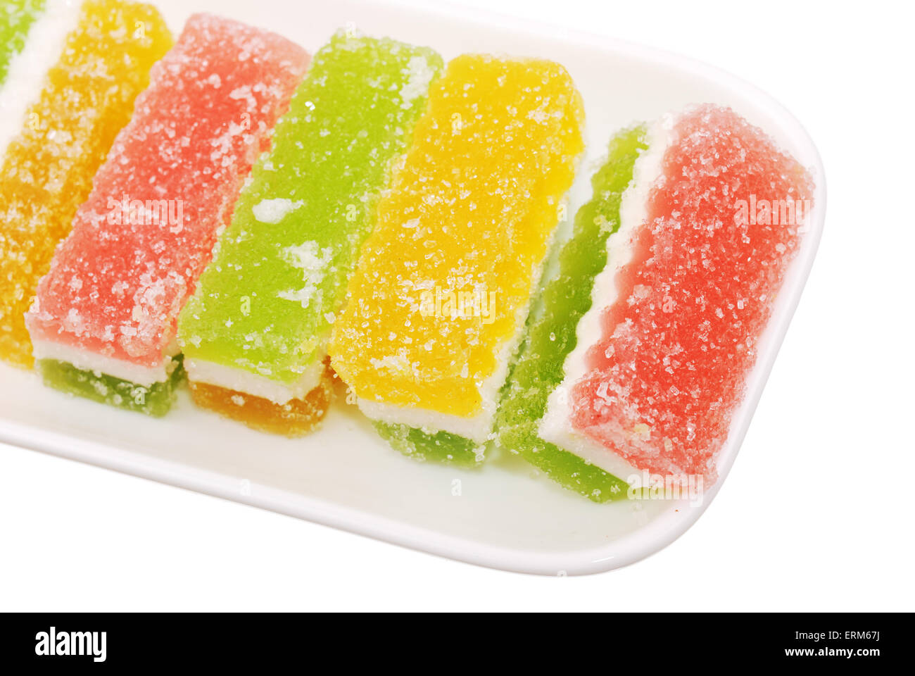 Fruit candy slices on plate isolated Stock Photo - Alamy