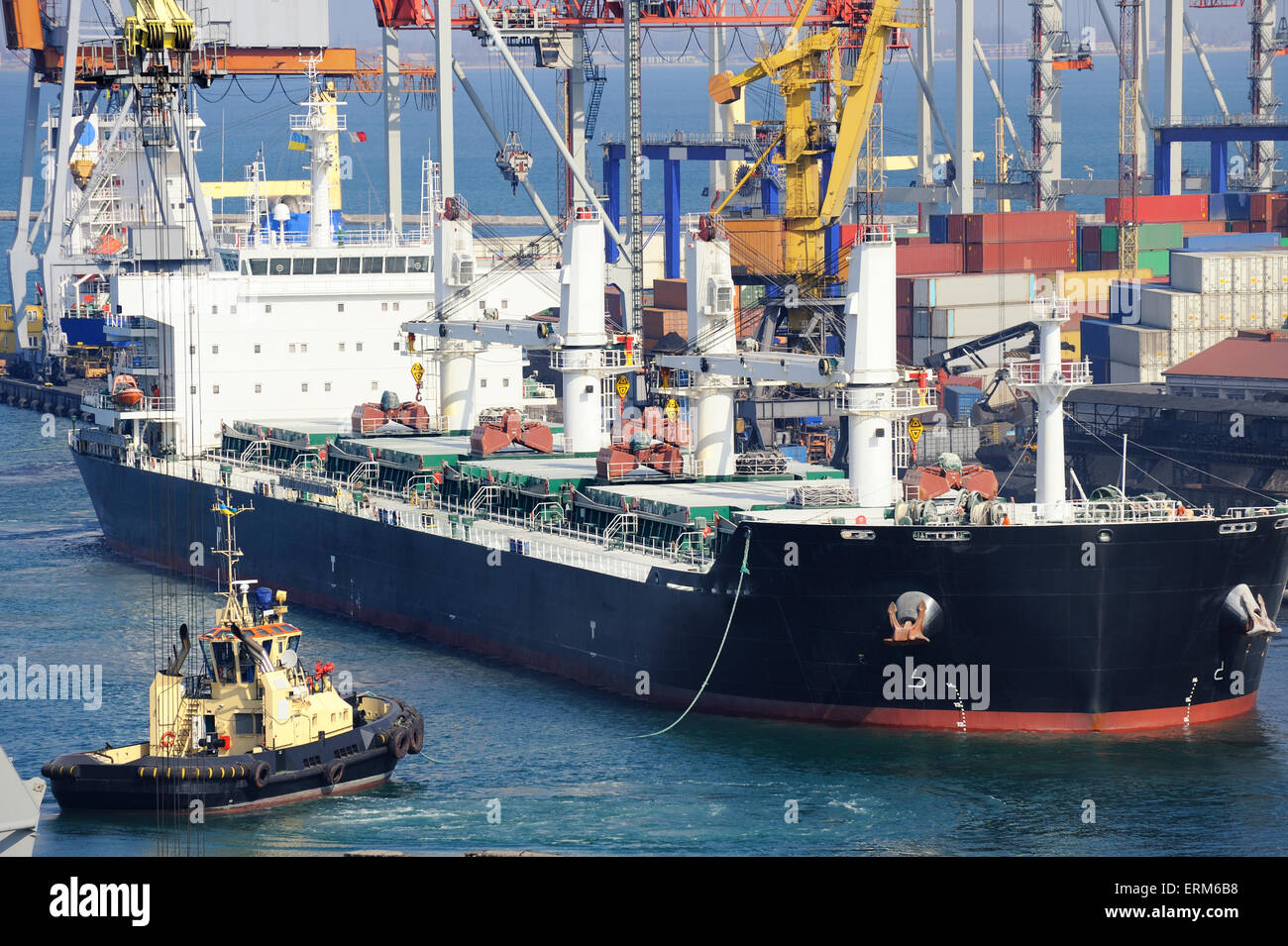 cargo ship and tug boat in port Stock Photo - Alamy