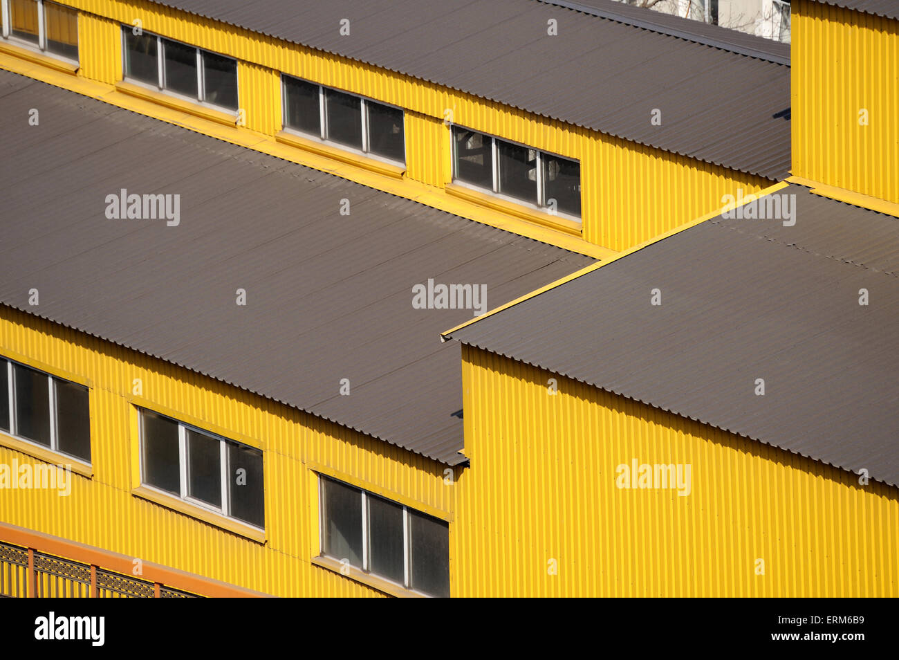 Yellow siding wall and roof as background Stock Photo - Alamy