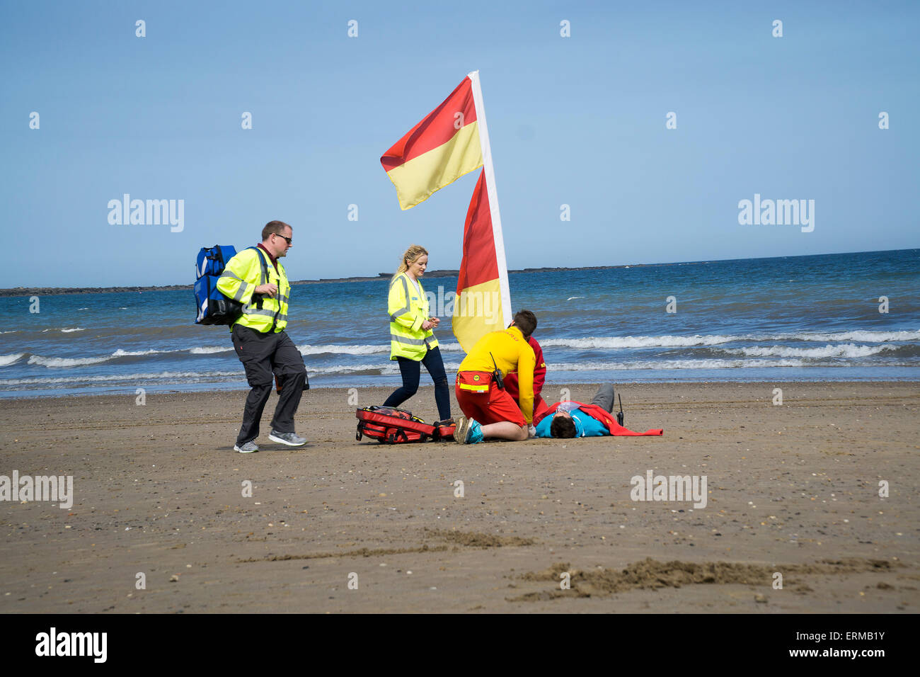 Rnli and paramedic first responers treat casualty on the beach Stock ...