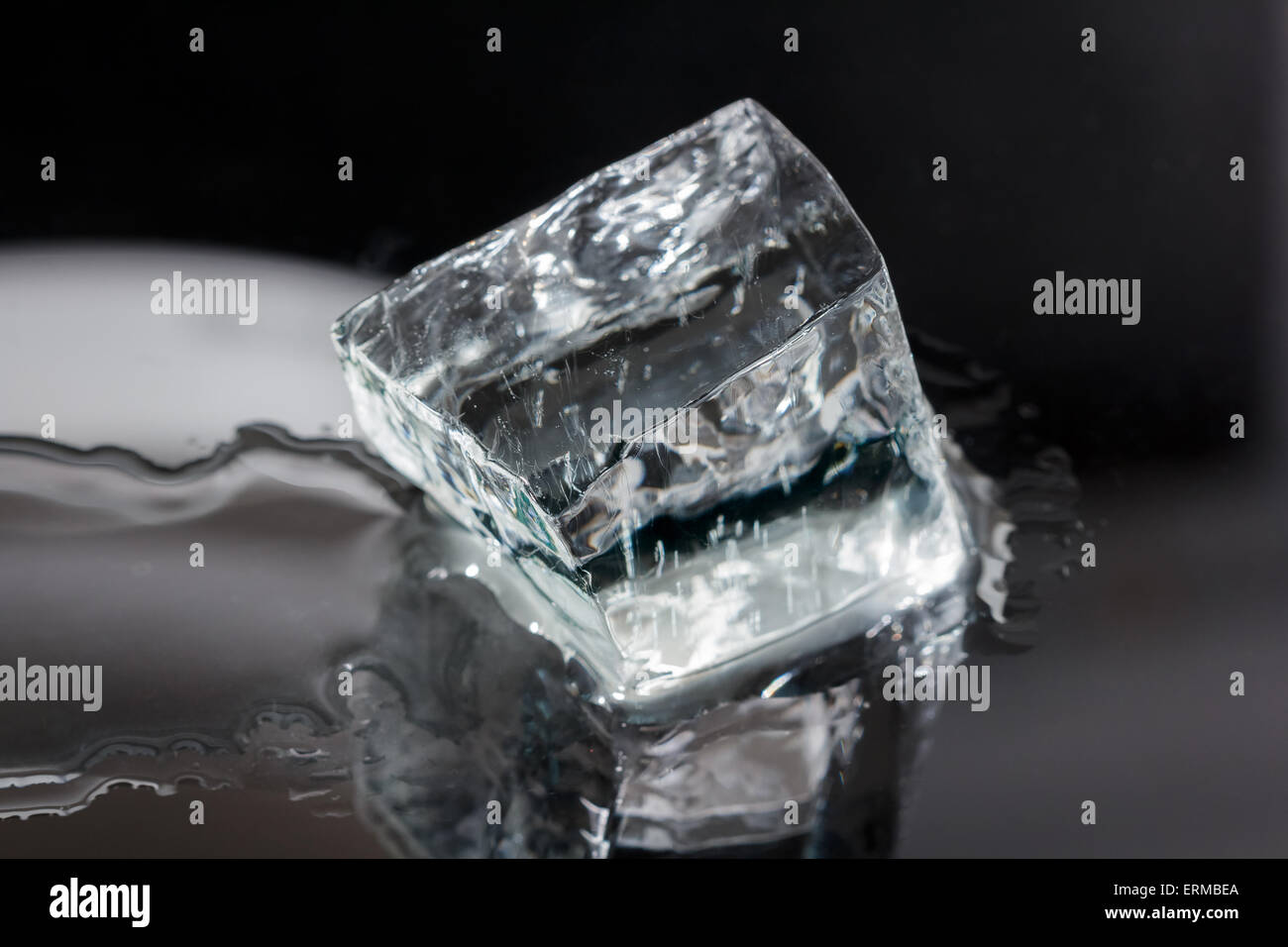 One big ice cube isolated on black Stock Photo - Alamy