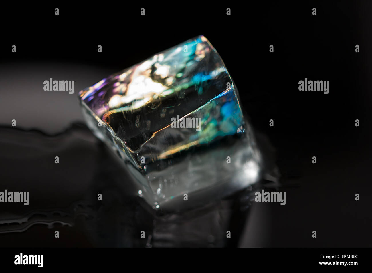 One big colorful ice cube isolated on black Stock Photo - Alamy