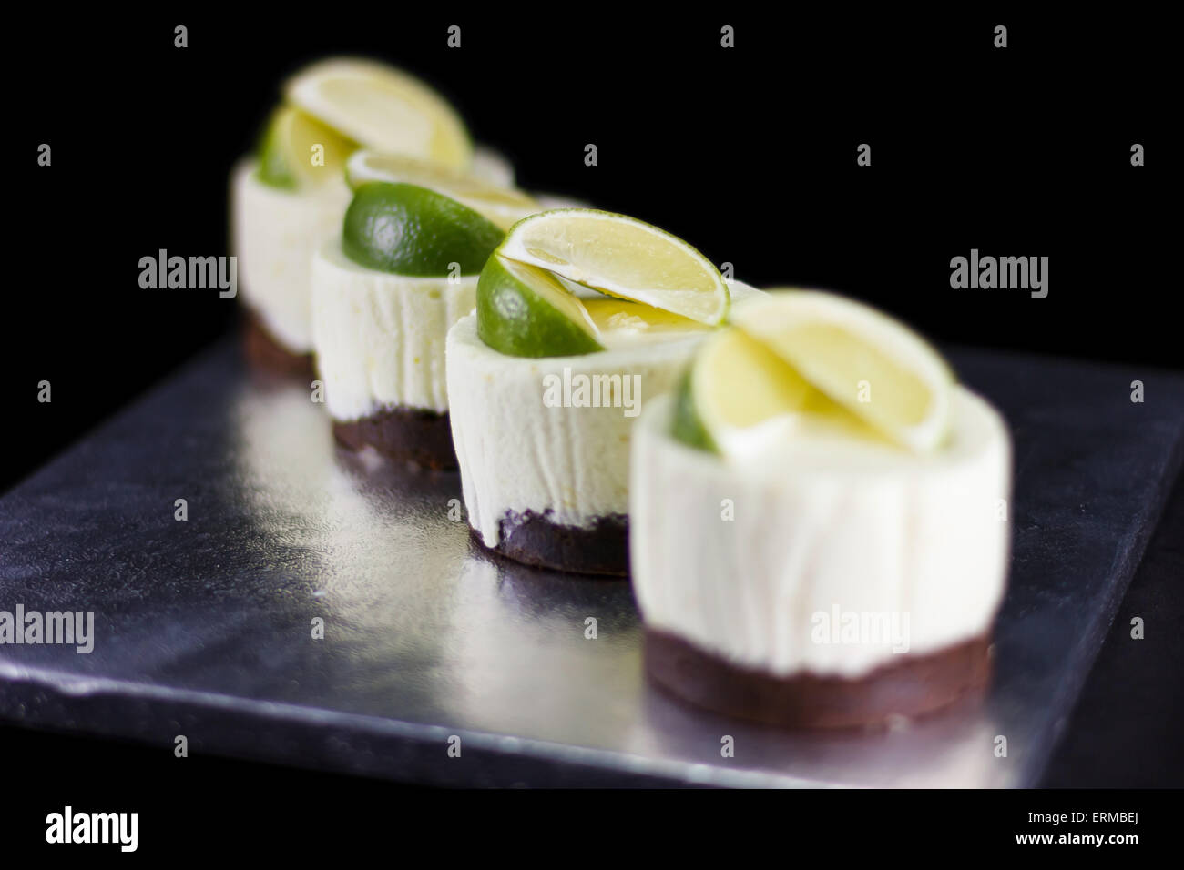 Four small cakes decorated with lime wedges Stock Photo - Alamy