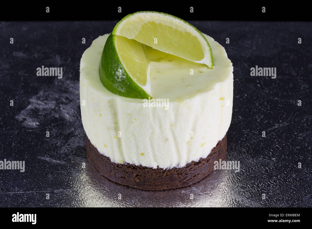 One small cake decorated with lime wedges Stock Photo - Alamy