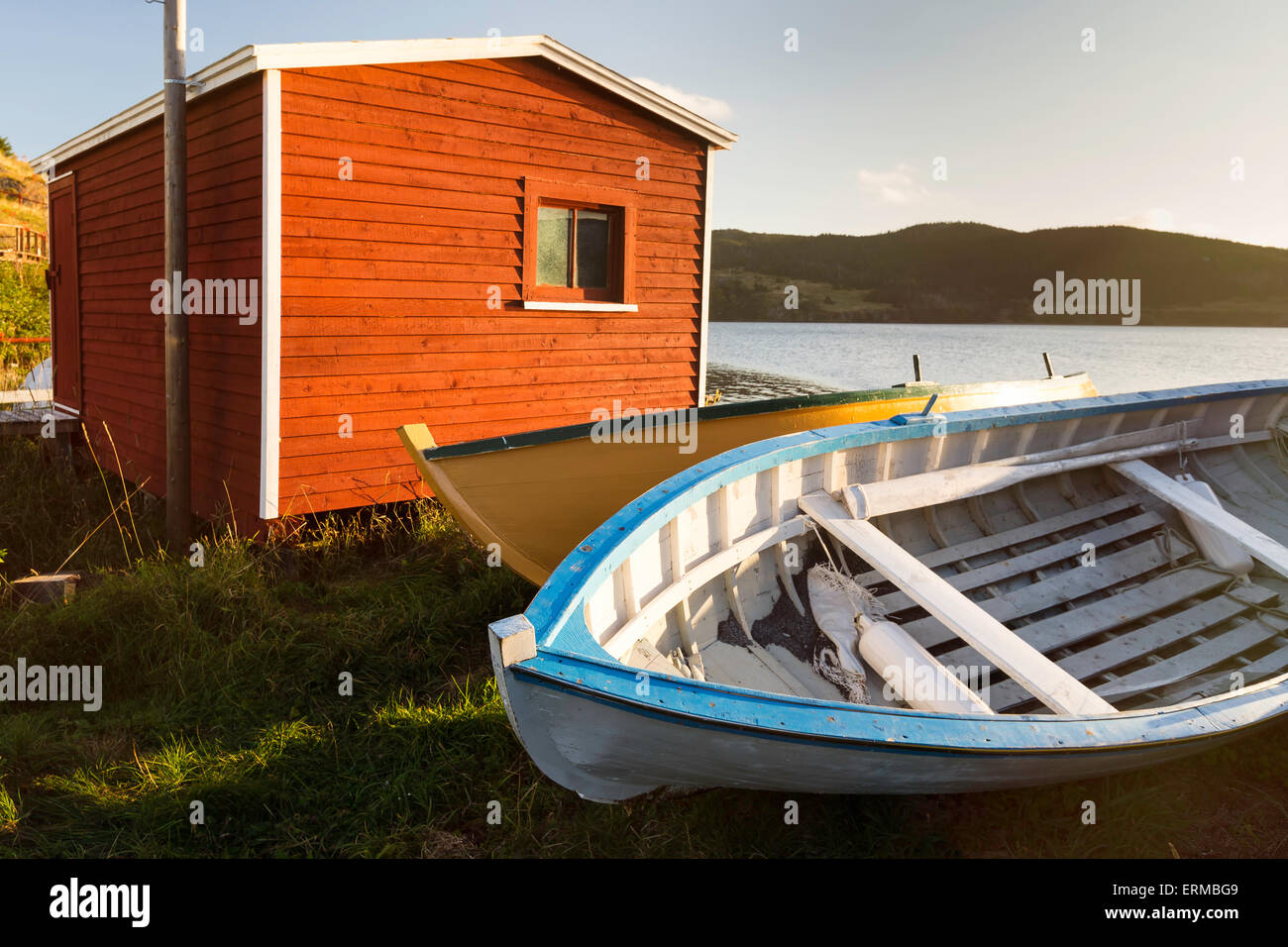 Newfoundland boats from a small rural fishing community under a golden ...