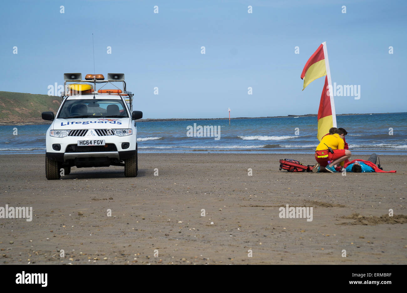 Rnli and paramedic first responders treat casualty on the beach Stock ...