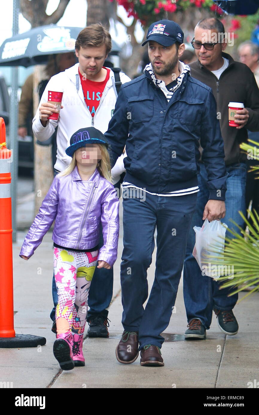 Jason Priestley takes a walk in the rain with his family through Studio ...