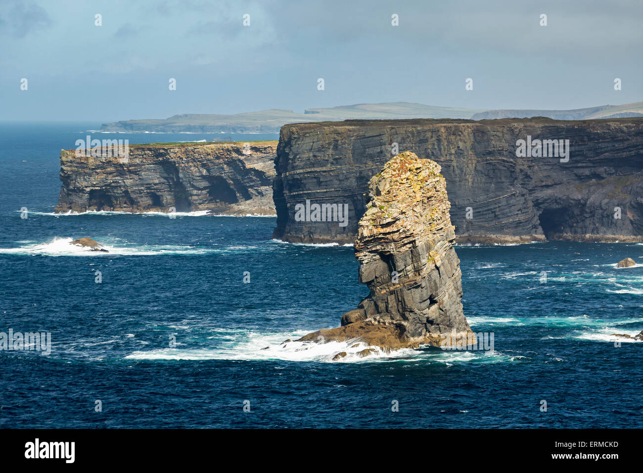 Large sea stack rock structure along rugged dramatic cliff shoreline ...