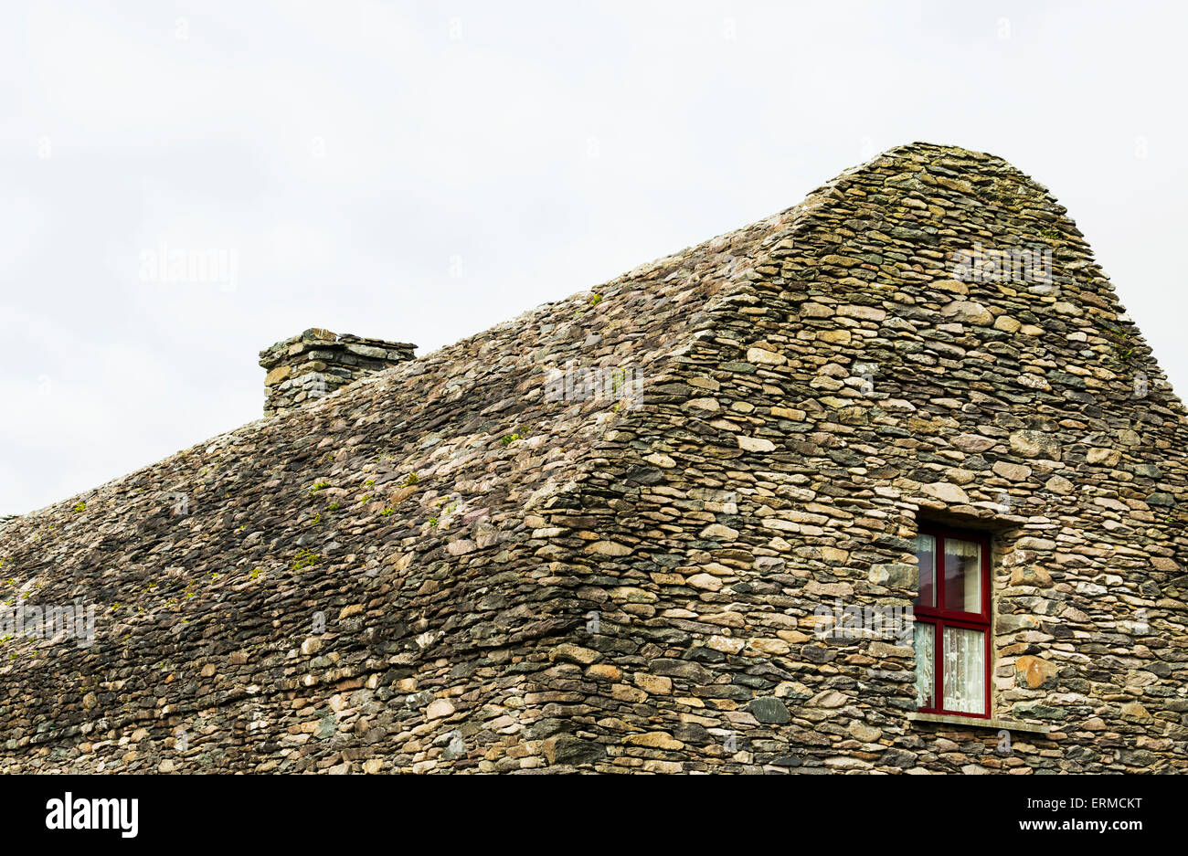 All stone building (bee hive structure) with small red framed window ...
