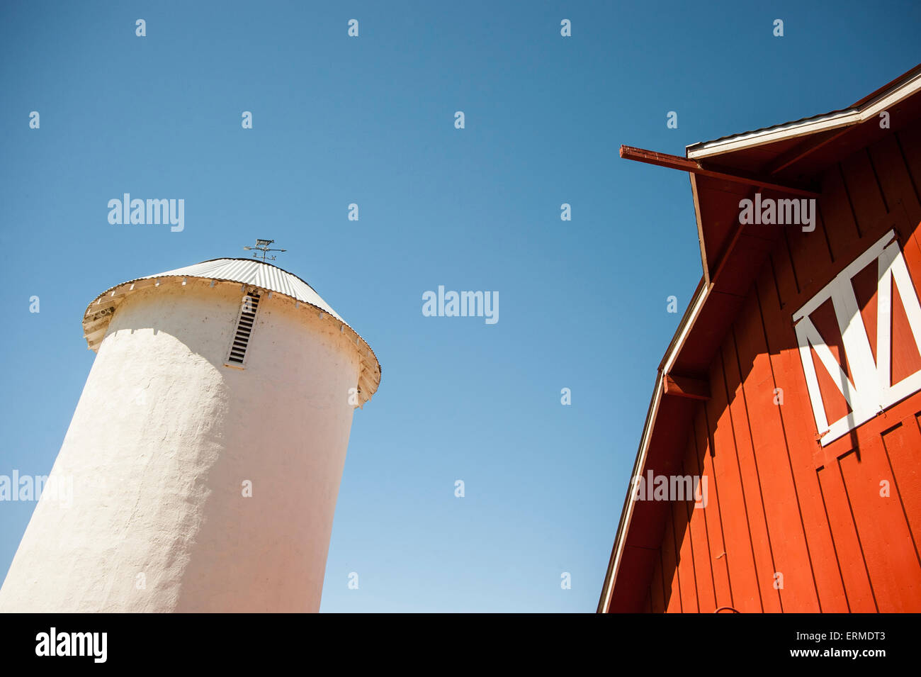Barnyard scene with red barn and white tower with weather vane on top ...