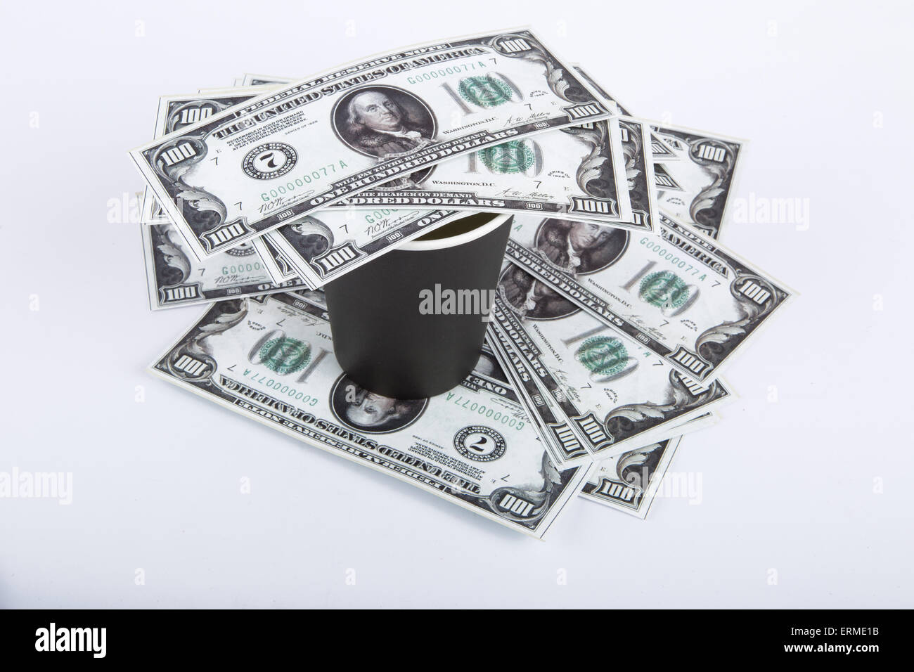 Close up top view of black paper glass with banknotes of one hundred ...