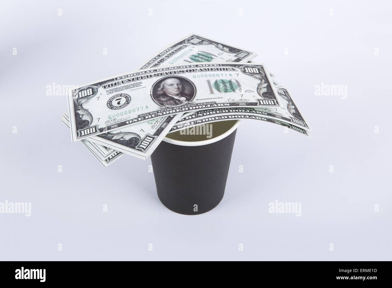 Close up top view of black paper glass with banknotes of one hundred ...