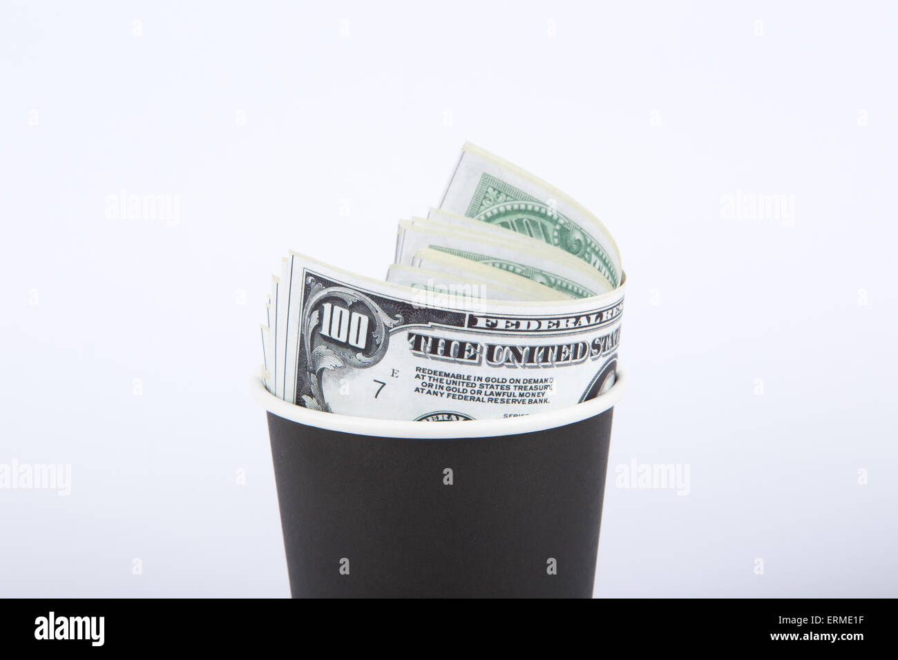 Close up front view of black paper glass with banknotes of one hundred ...