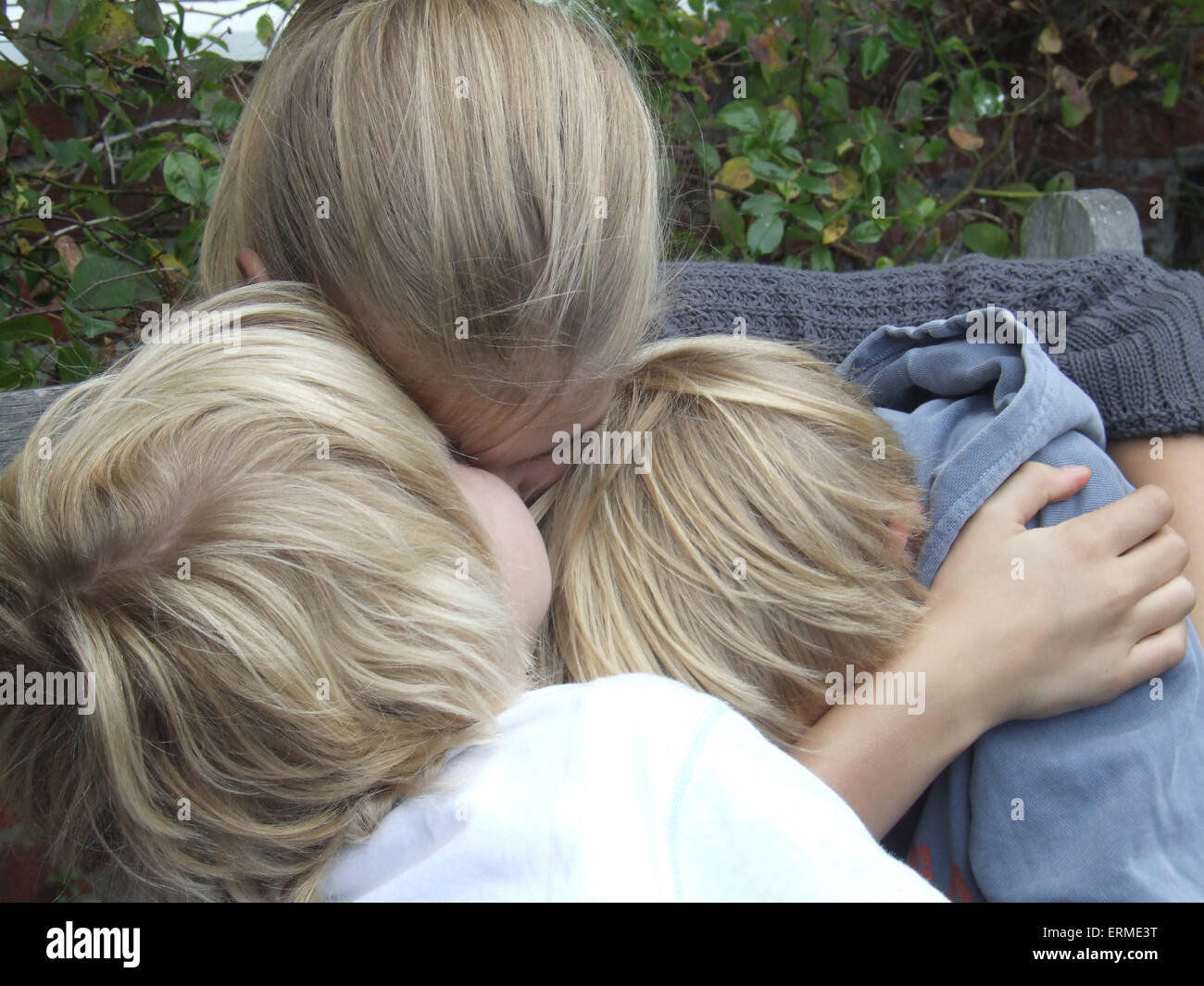 Little blonde sisters hugging hi-res stock photography and images - Alamy