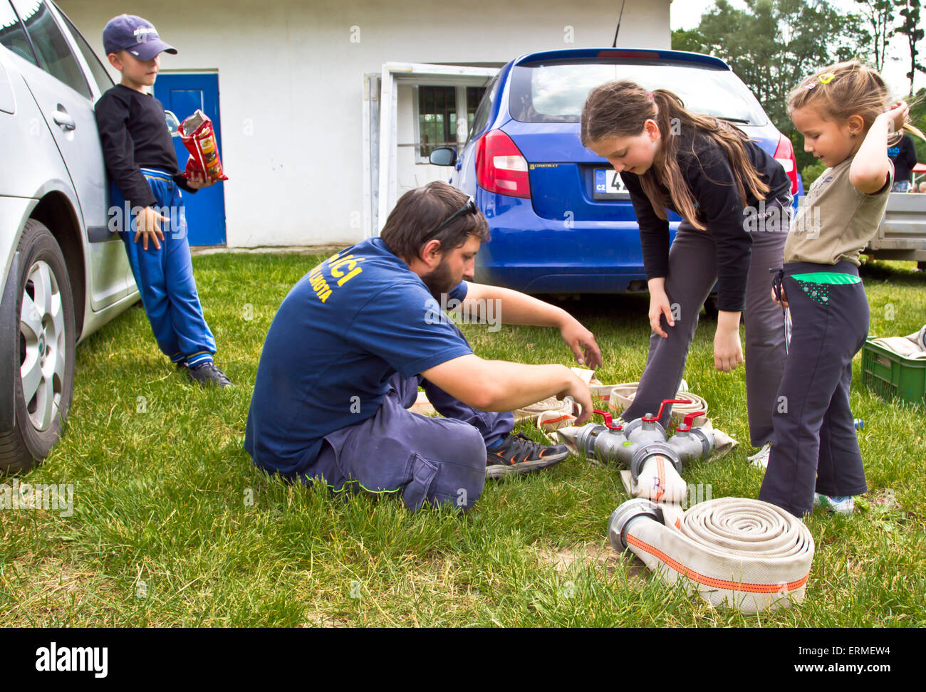 Volunteer firefighters training children Stock Photo - Alamy