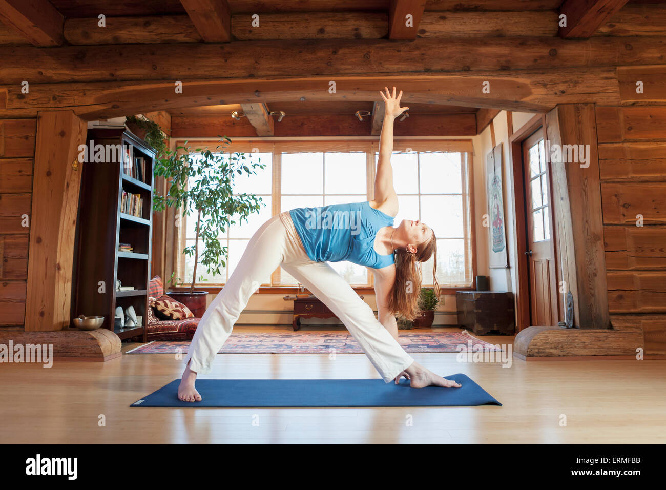 Woman practices yoga at indoor studio, Homer, Alaska Stock Photo - Alamy