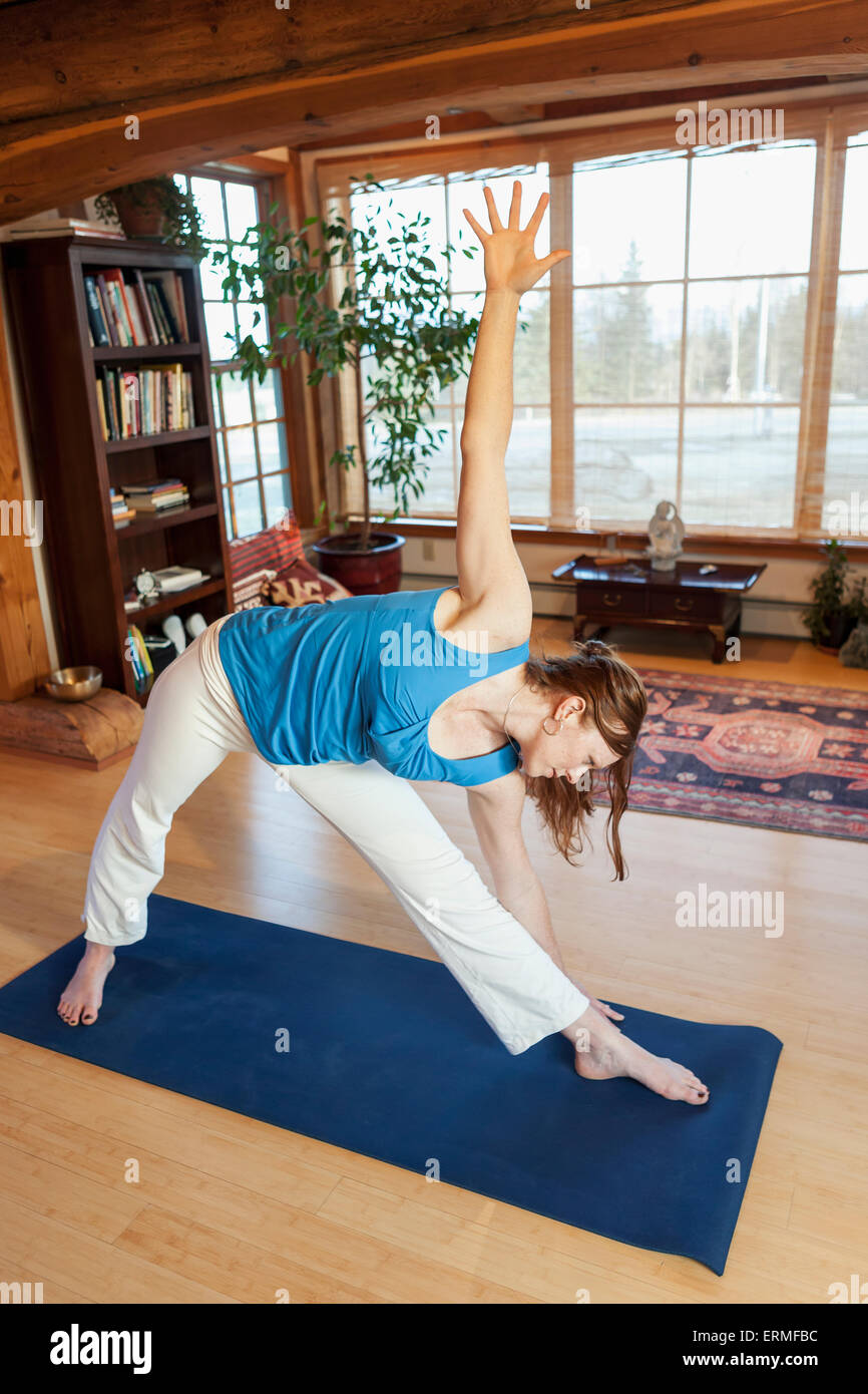 Woman practices yoga at indoor studio, Homer, Alaska Stock Photo - Alamy