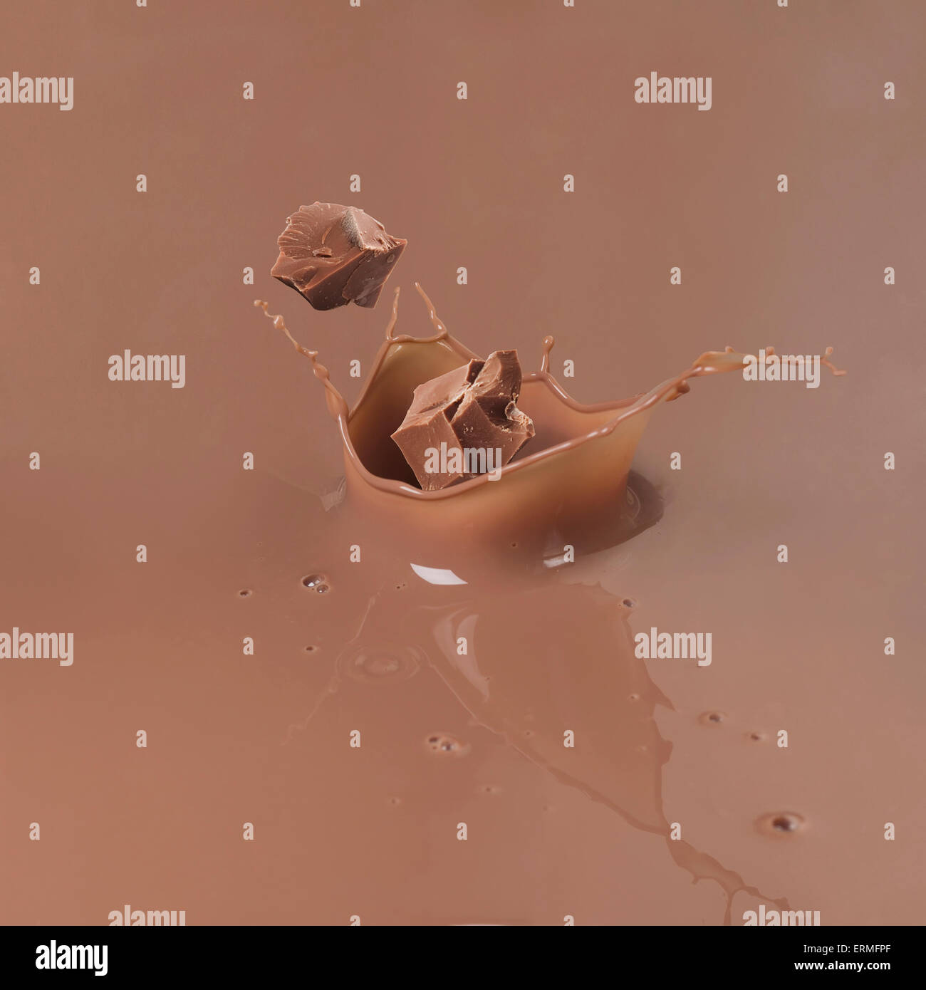 Pieces of chocolate splashing into melted chocolate Stock Photo - Alamy