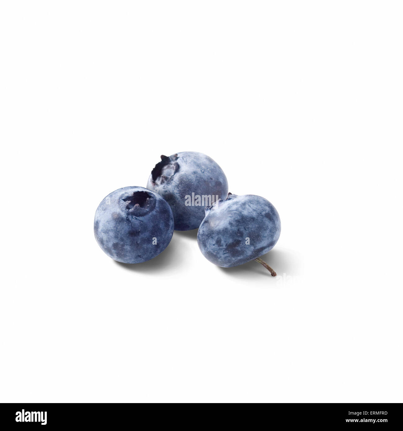 Three blueberries on a white background Stock Photo - Alamy