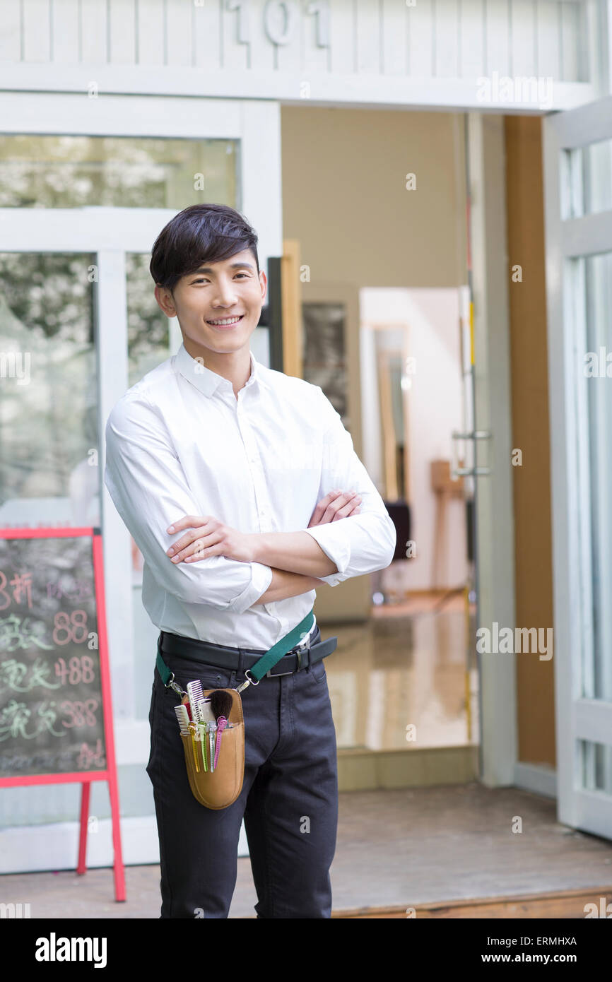 Male barber standing in doorway of barber shop Stock Photo - Alamy