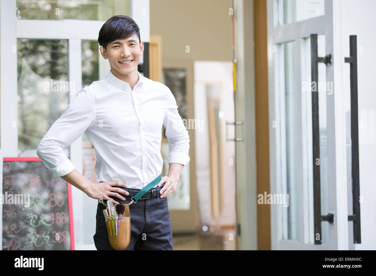 Male barber standing in doorway of barber shop Stock Photo - Alamy