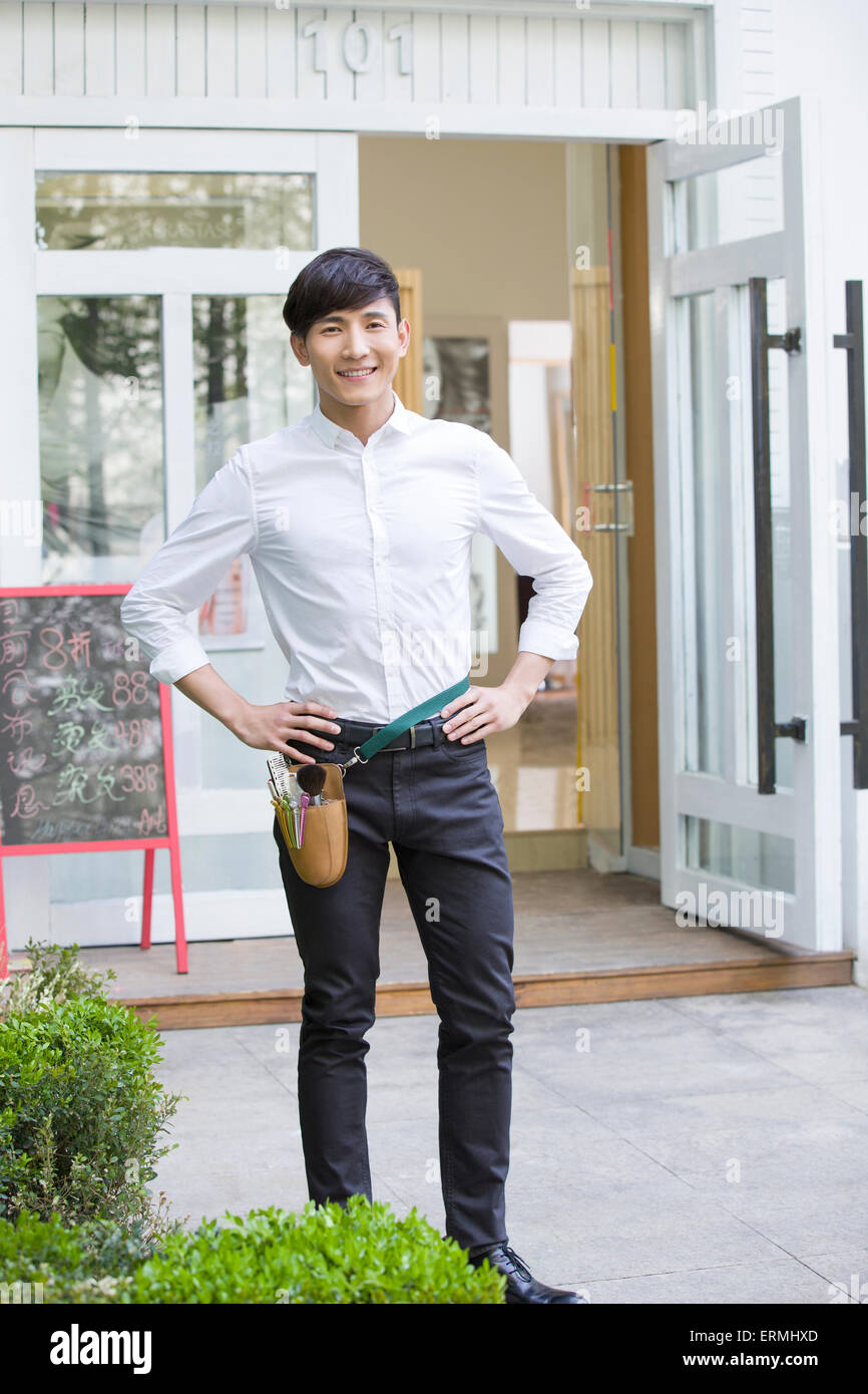 Male barber standing in doorway of barber shop Stock Photo - Alamy