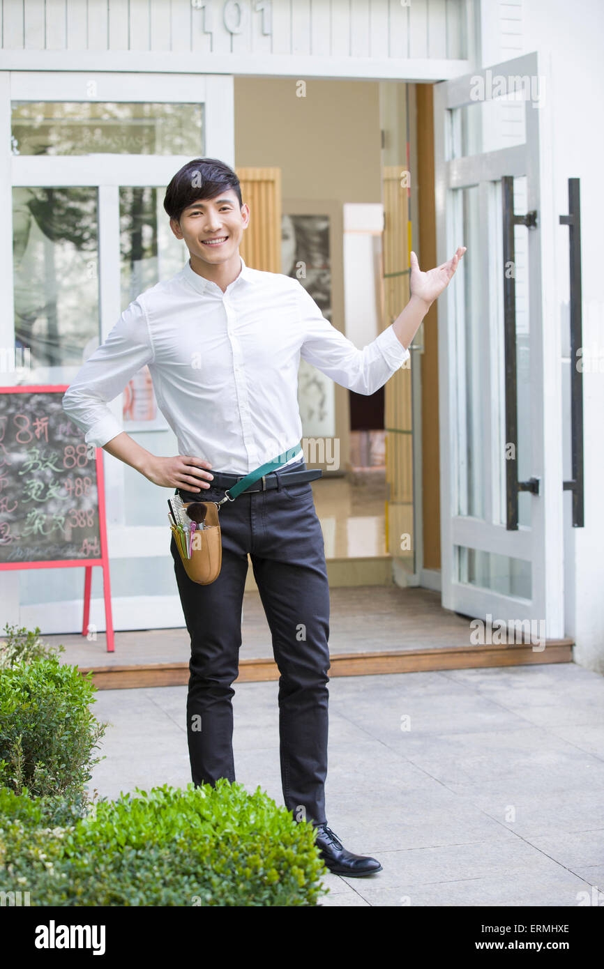 Male barber standing in doorway of barber shop Stock Photo - Alamy