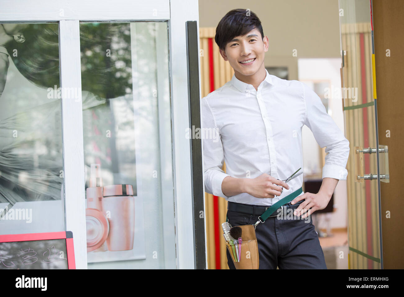 Male barber standing in doorway of barber shop Stock Photo - Alamy