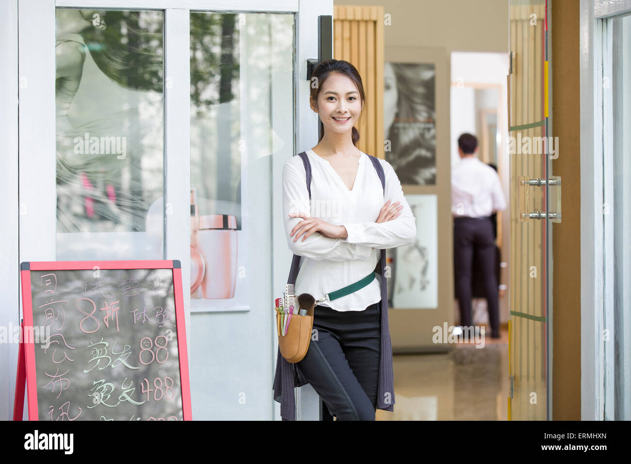 Female barber standing in doorway of barber shop Stock Photo - Alamy