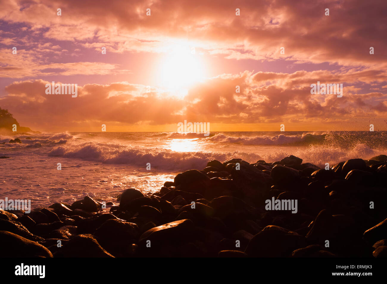 Sunrise and waves crashing on the rocks, Kealia Beach; Kauai, Hawaii ...