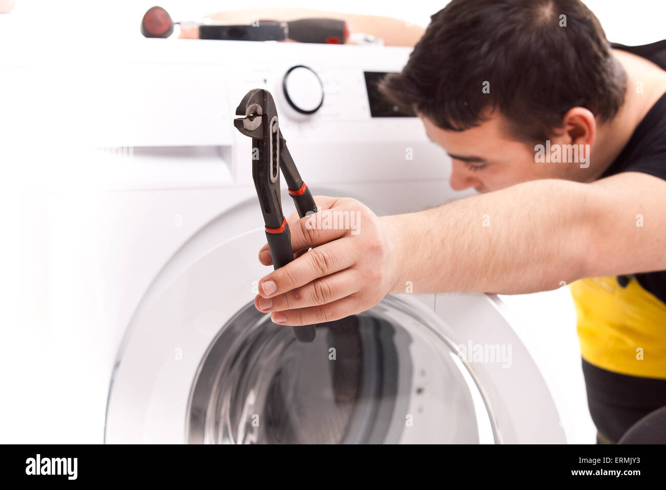 studio photo of washing machine repairman Stock Photo - Alamy