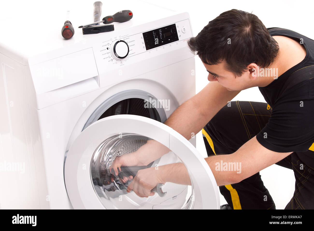studio photo of washing machine repairman Stock Photo - Alamy