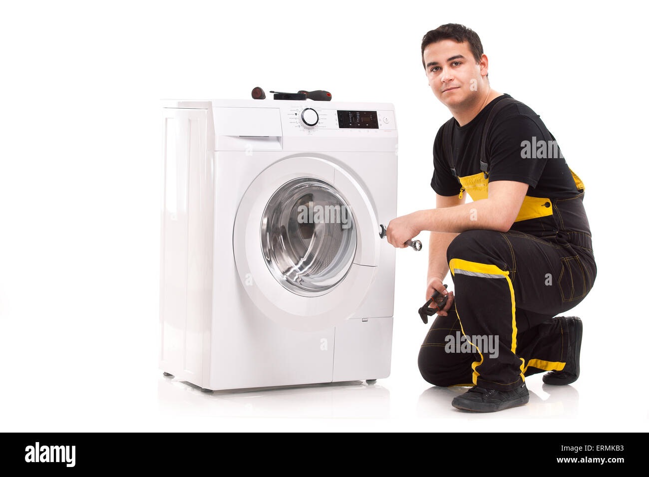 studio photo of washing machine repairman Stock Photo - Alamy
